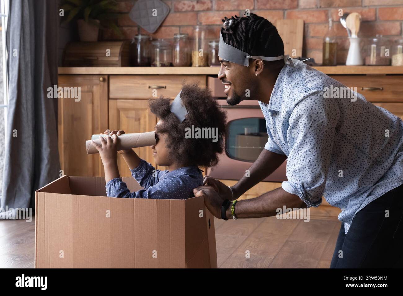 Happy African American father with little daughter playing pirates game ...