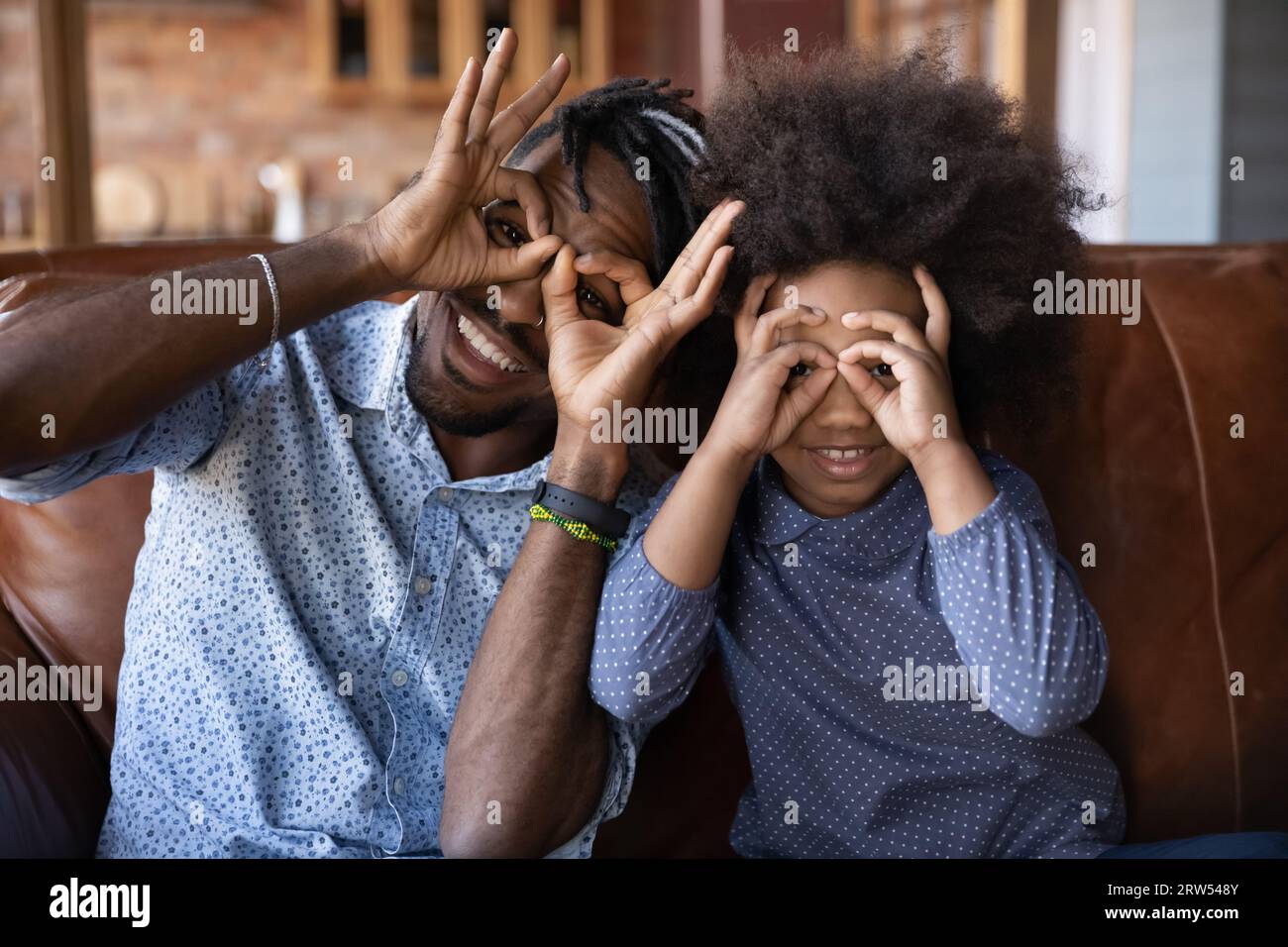 Head shot portrait smiling father with daughter making funny faces ...