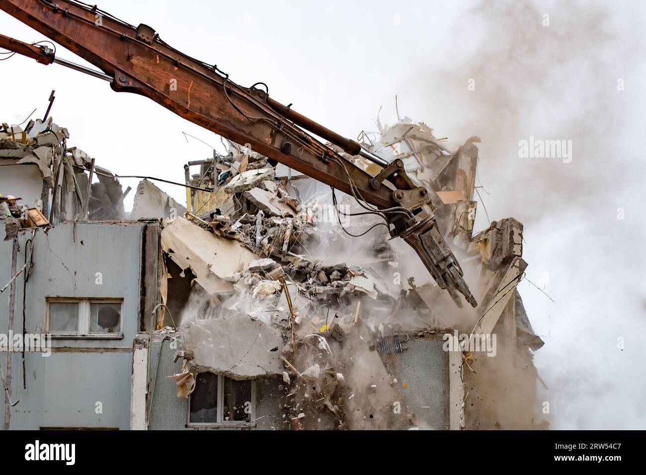 Demolition of a residential house using building hydraulic shears Stock ...