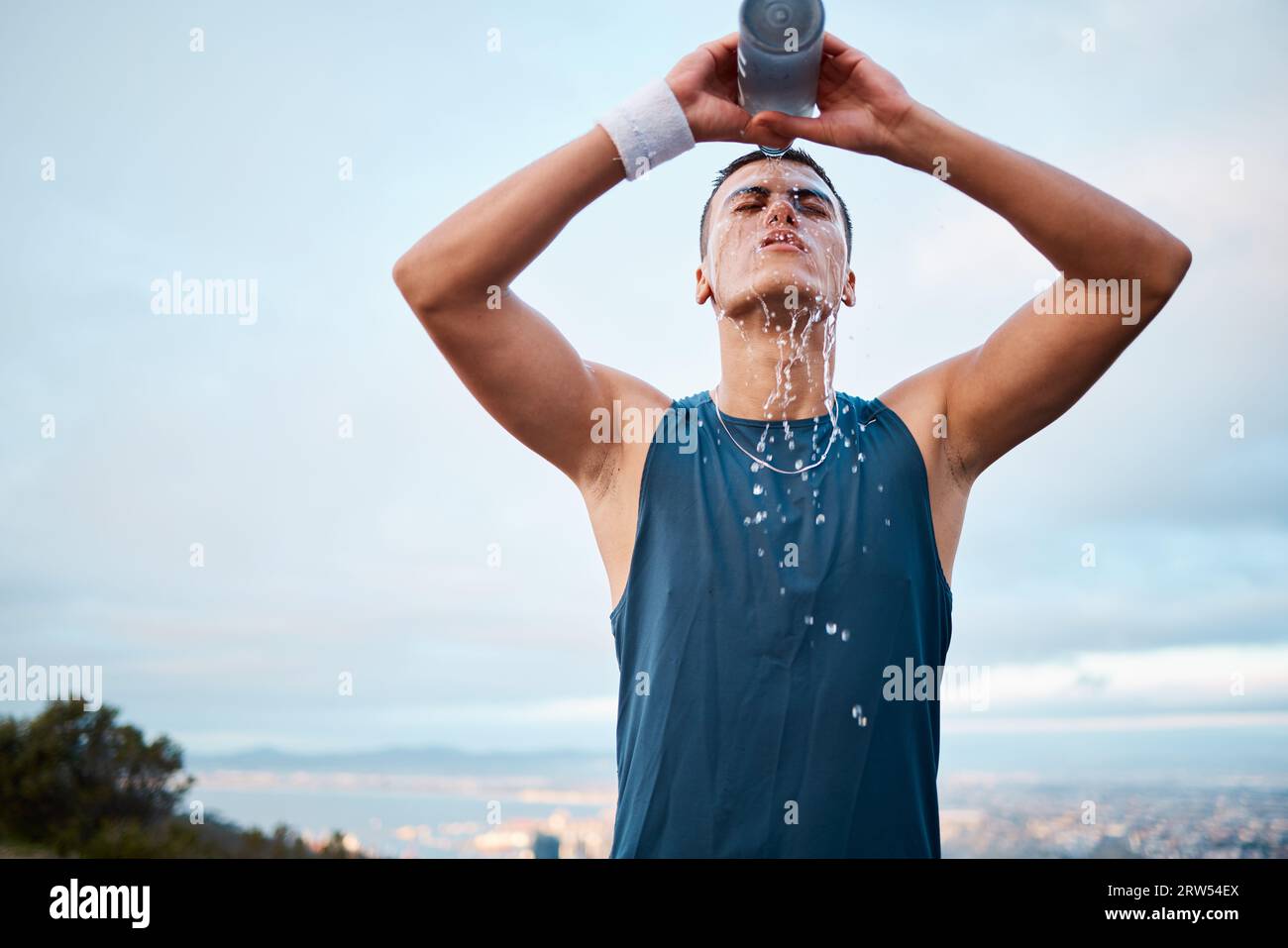Exercise, water and fatigue with a sports man outdoor, tired after ...