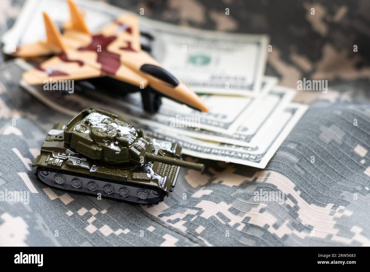 Tank on dollar banknotes. The concept of war costs, military spending ...