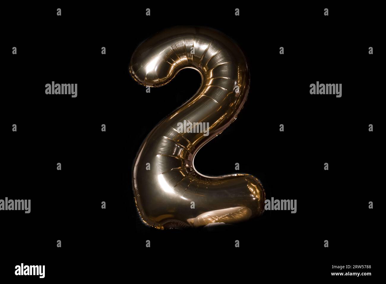 Number 2 two digits inflated from a balloon air object on a black ...