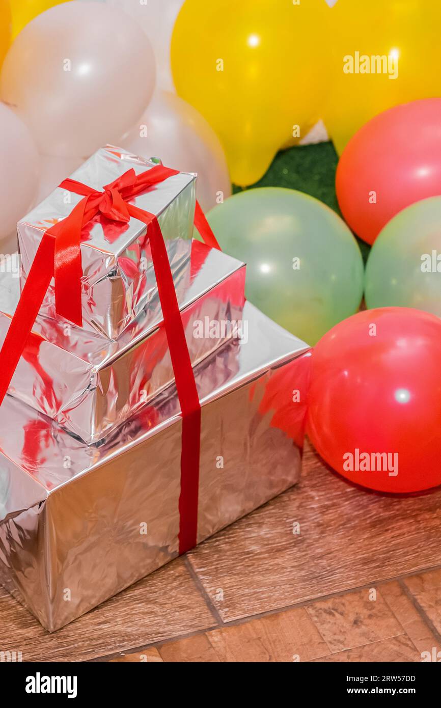 A bunch of many New Year's gift boxes in silver packaging with a red ...