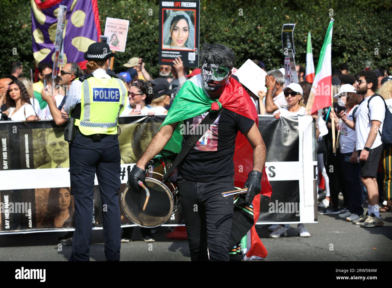 London, UK. 16th Sep, 2023. A drummer with a face mask in the colours ...