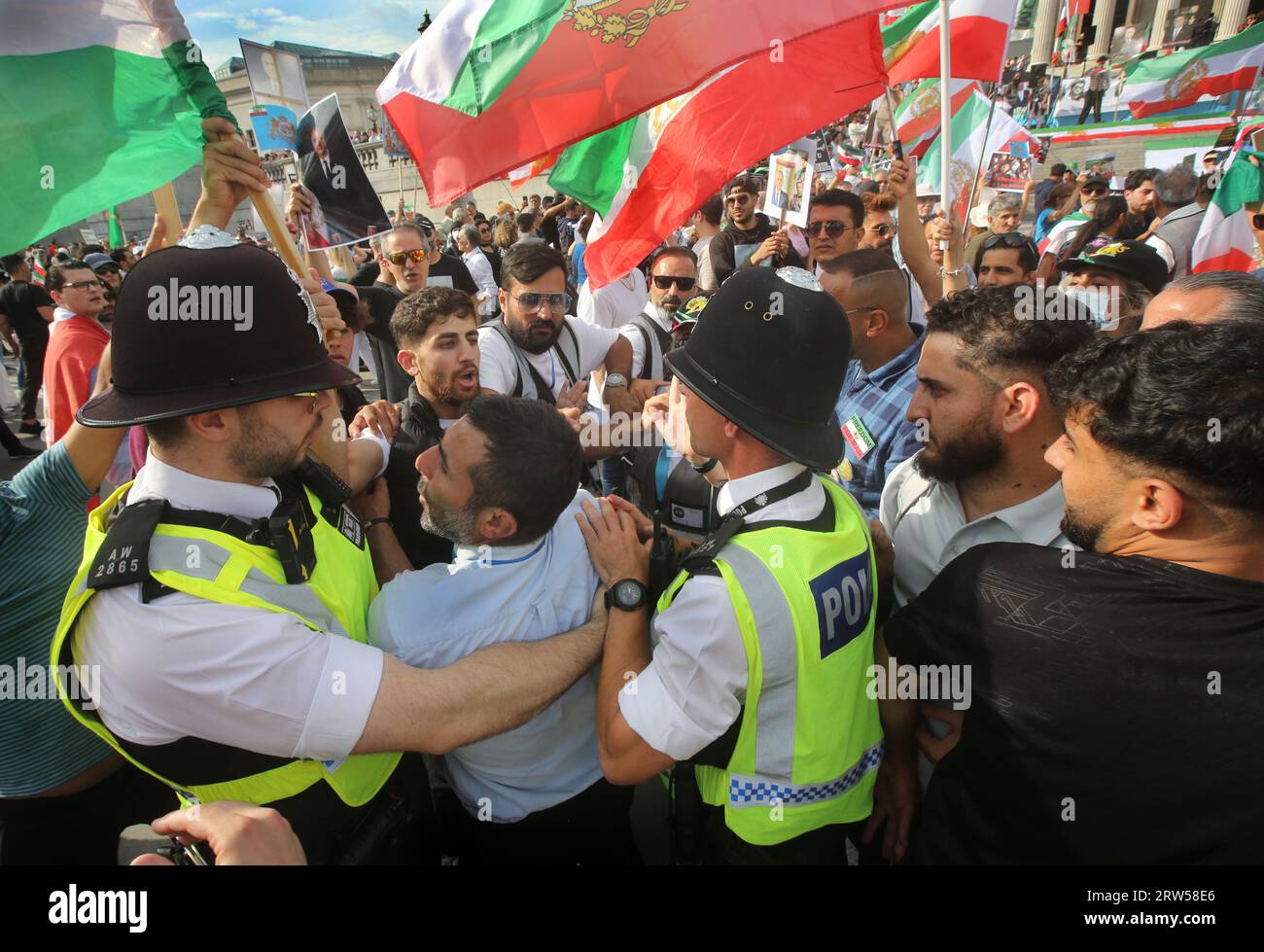 Police officers move in to prevent trouble between a flag carrying Kurdish group and Royalists ...