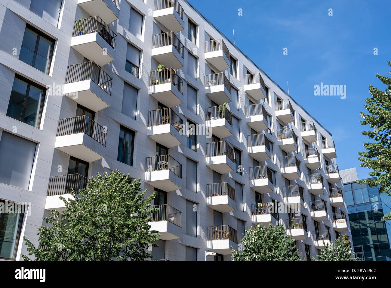 White apartment building with many small balconies seen in Berlin ...