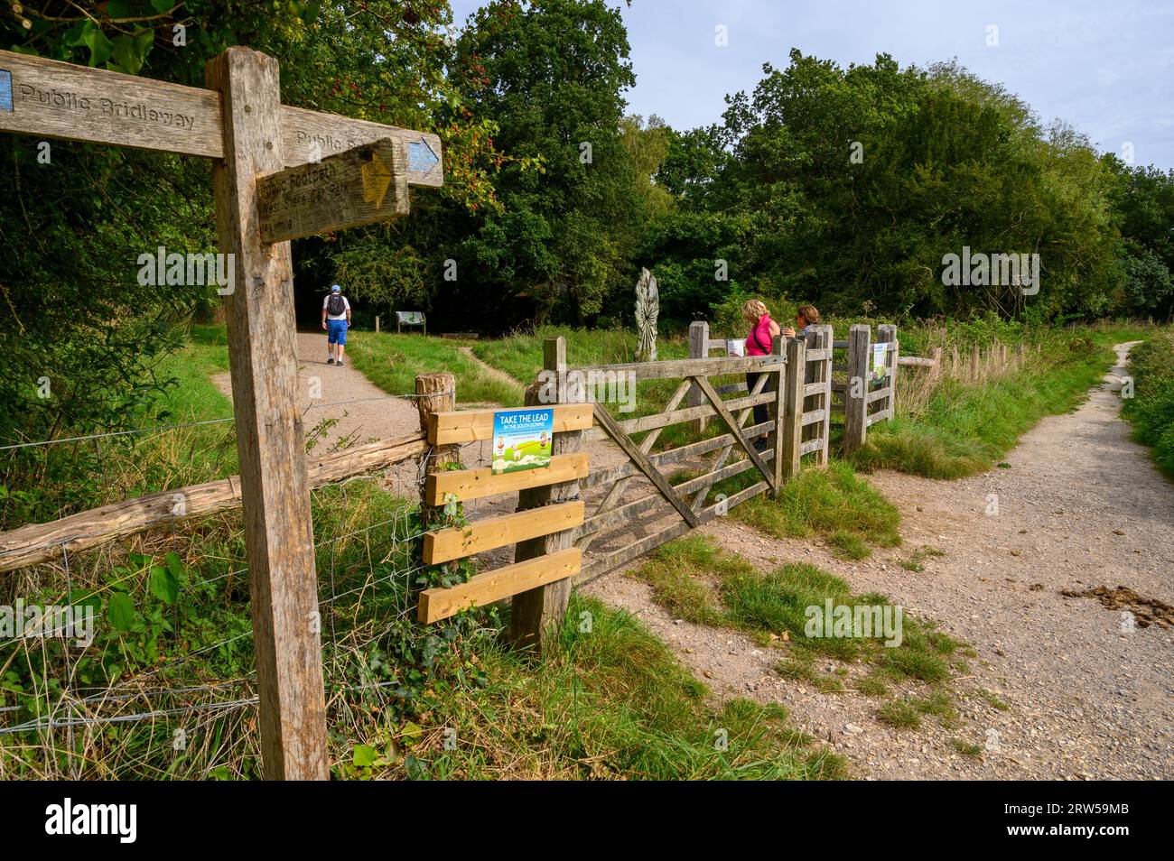 Visitors enter Kingley Vale National Nature Reserve through a wooden ...