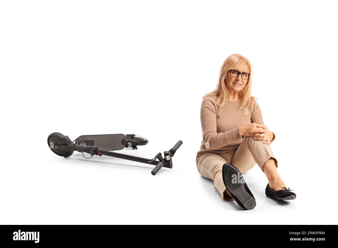 Woman falling from an electric scooter isolated on white background ...