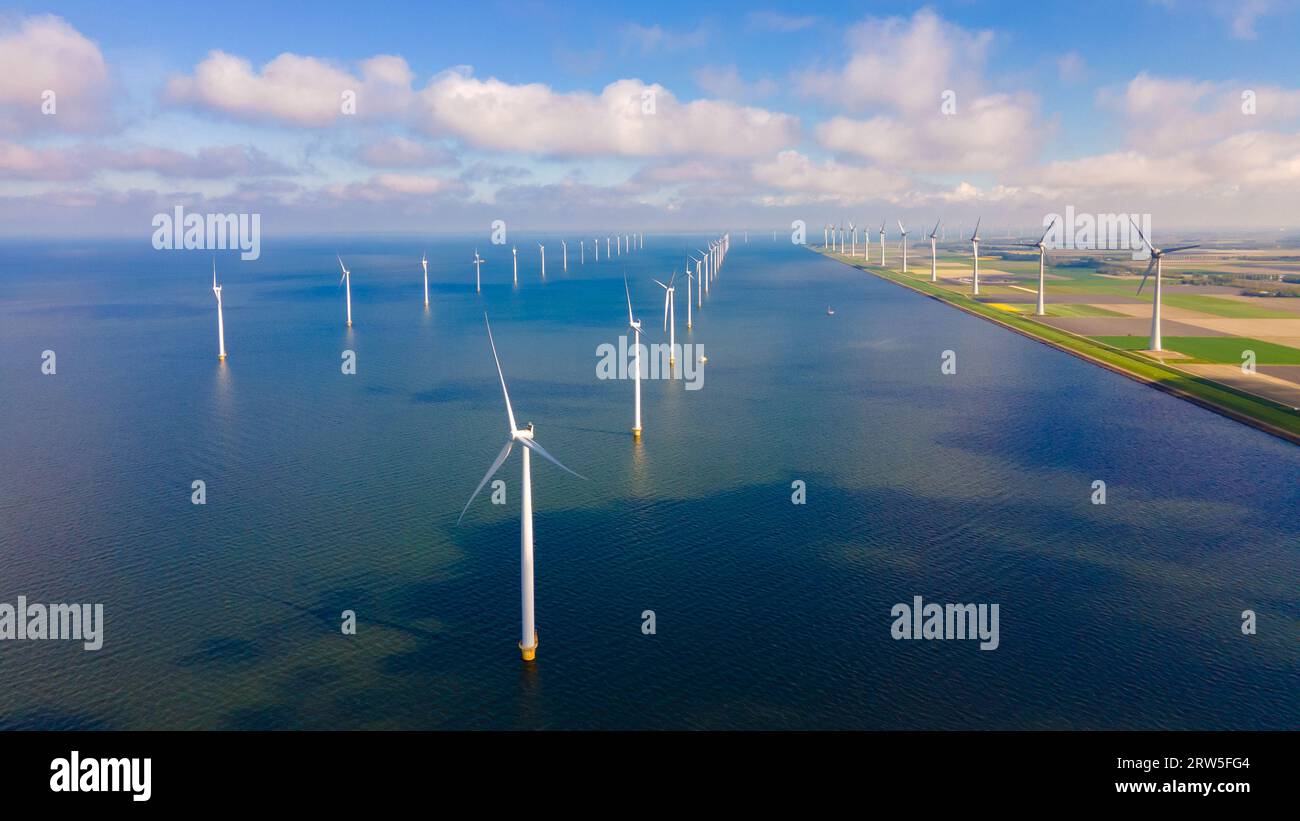 Wind turbine offshore plant in an ocean at sunrise, alternative energy ...