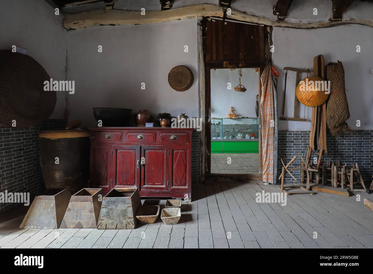 Old style furniture and farm tools are displayed in a folk museum in a ...