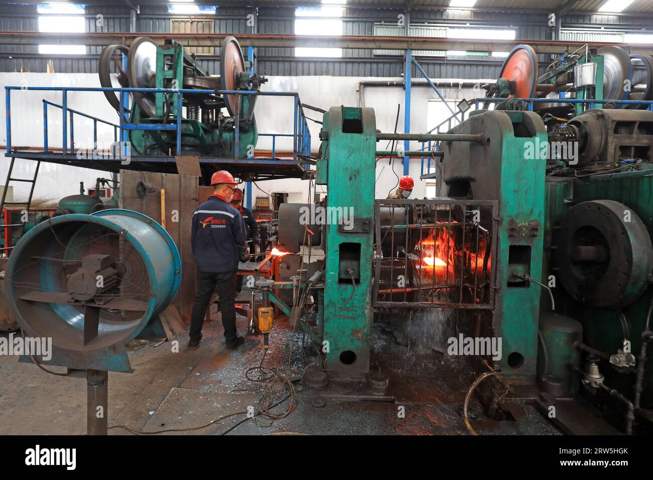 LUANNAN COUNTY, China - April 22, 2021: workers work hard on the steel ...