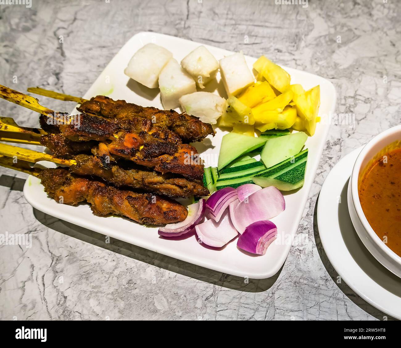Satay is a Southeast Asian dish of seasoned, skewered and grilled meat ...