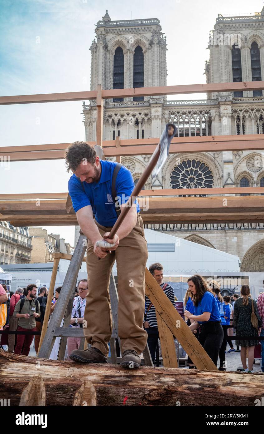 A French artisan woodworker demonstrates using a traditional axe to ...