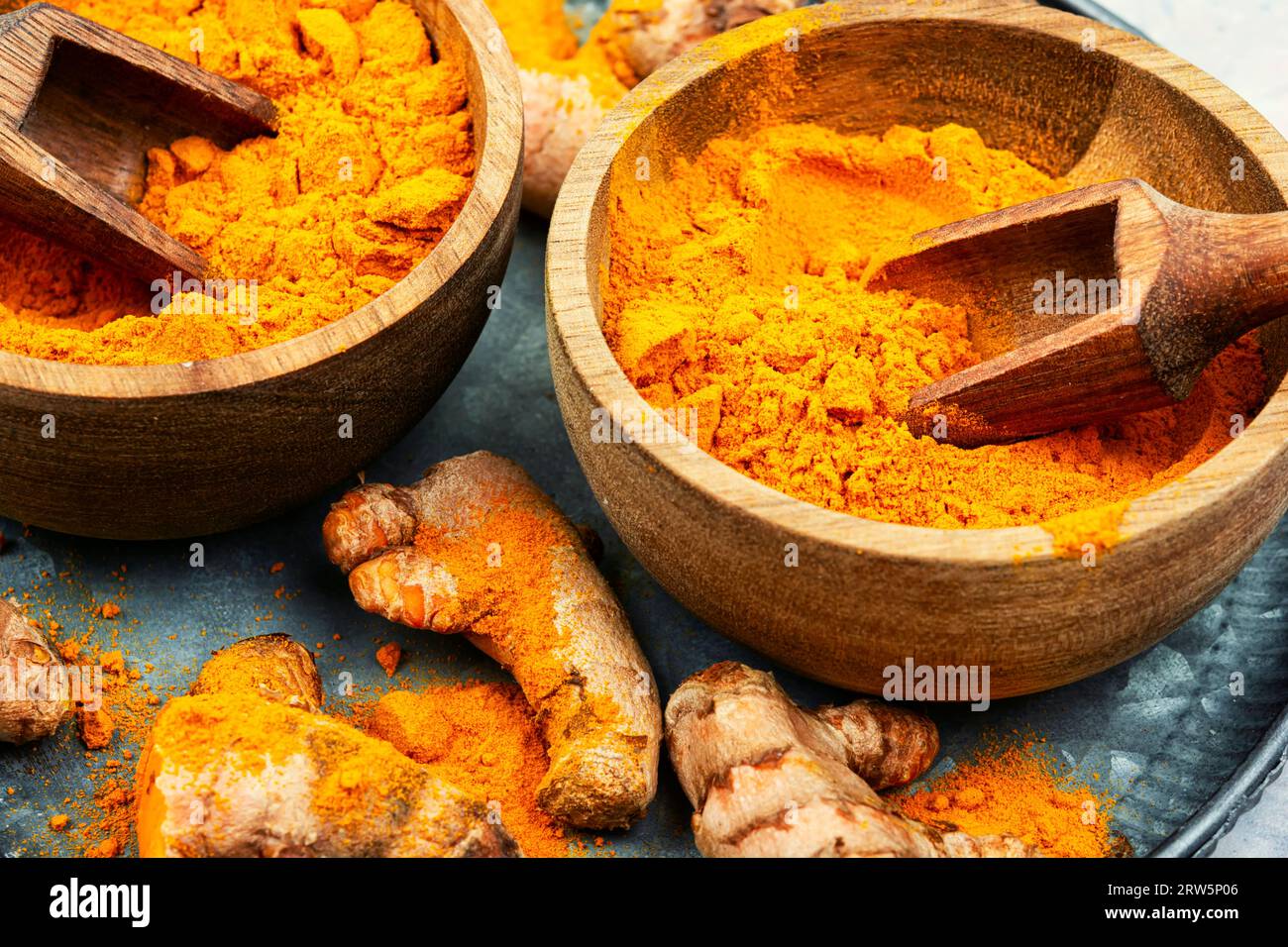 Dried turmeric roots in a wooden bowl. Turmeric spice Stock Photo - Alamy