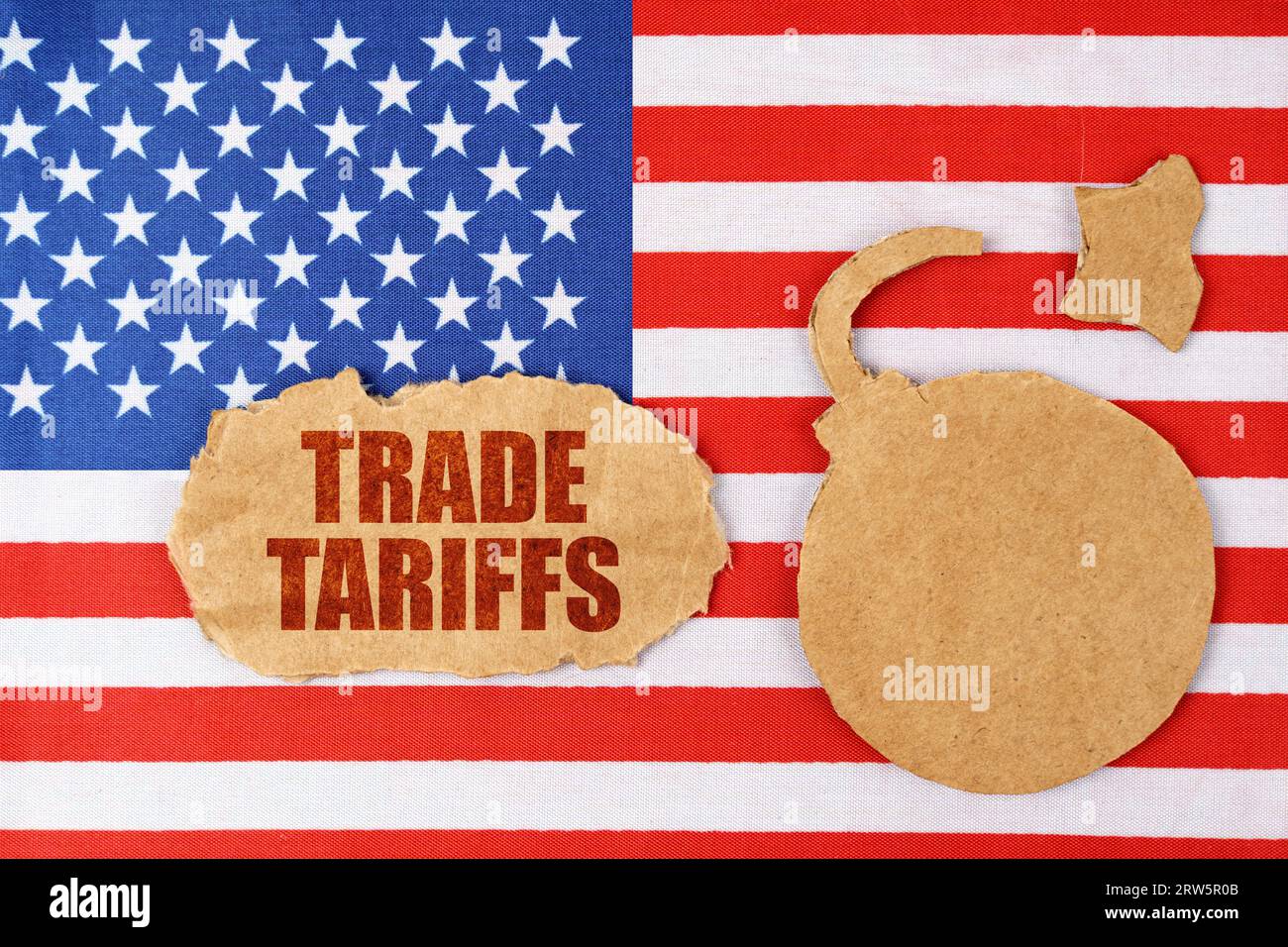 On the flag of the United States are a bomb cut out of cardboard and a ...
