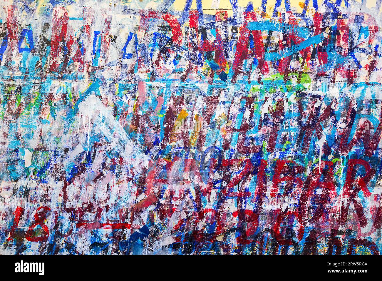 painted random letters lines and shapes on a flat but textured wall ...