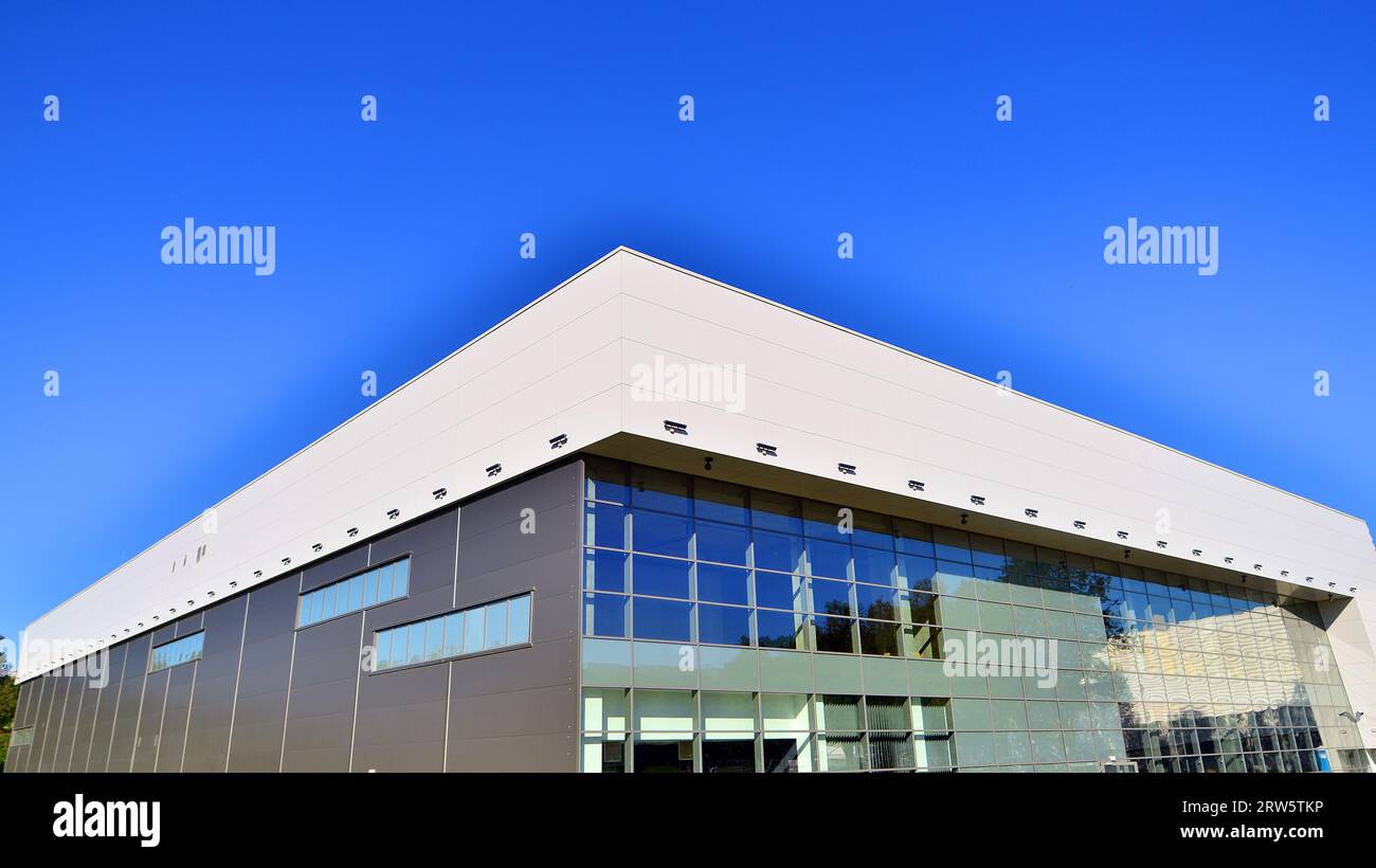 Minimalist photo of an exterior of a modern tin building with big glass ...