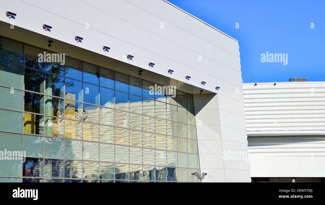 Minimalist photo of an exterior of a modern tin building with big glass ...