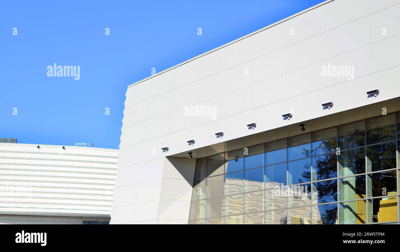 Minimalist photo of an exterior of a modern tin building with big glass ...