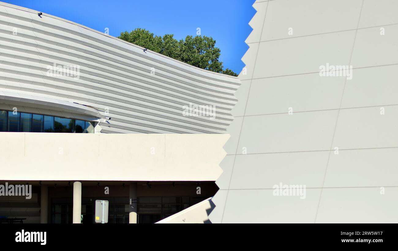 Minimalist photo of an exterior of a modern tin building with big glass ...