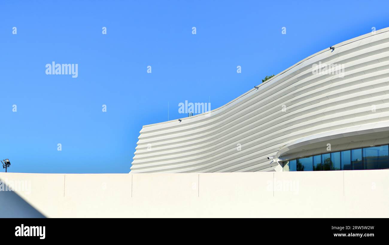 Minimalist photo of an exterior of a modern tin building with big glass ...