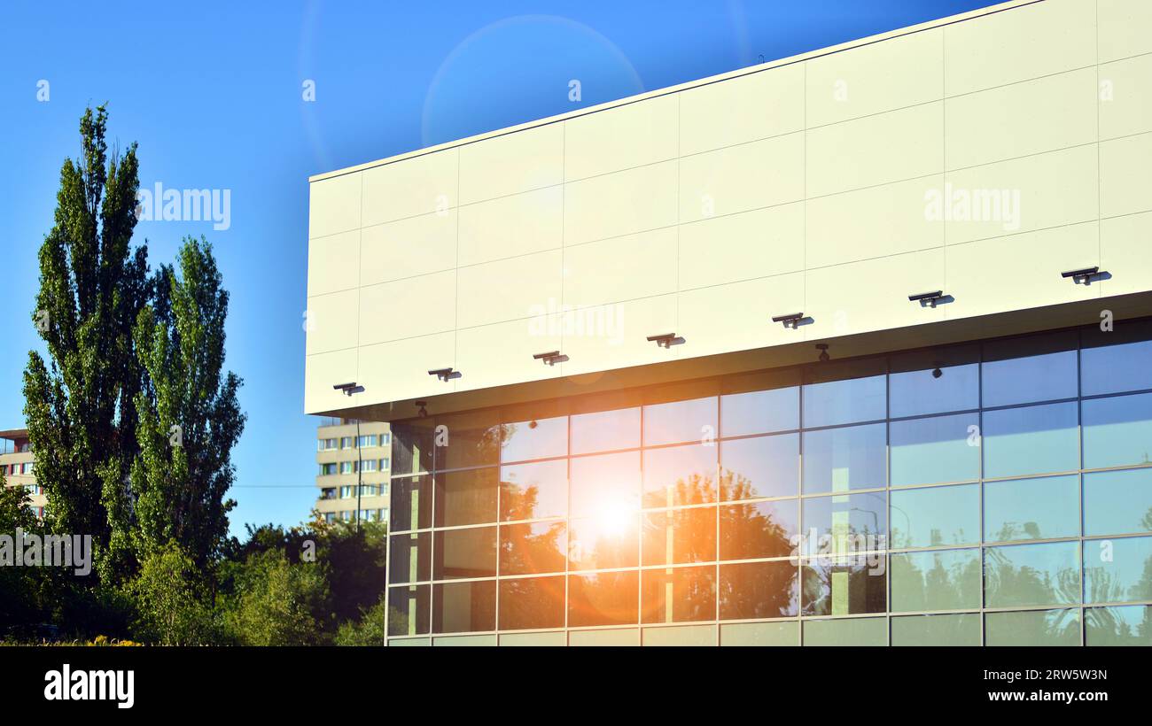 Minimalist photo of an exterior of a modern tin building with big glass ...