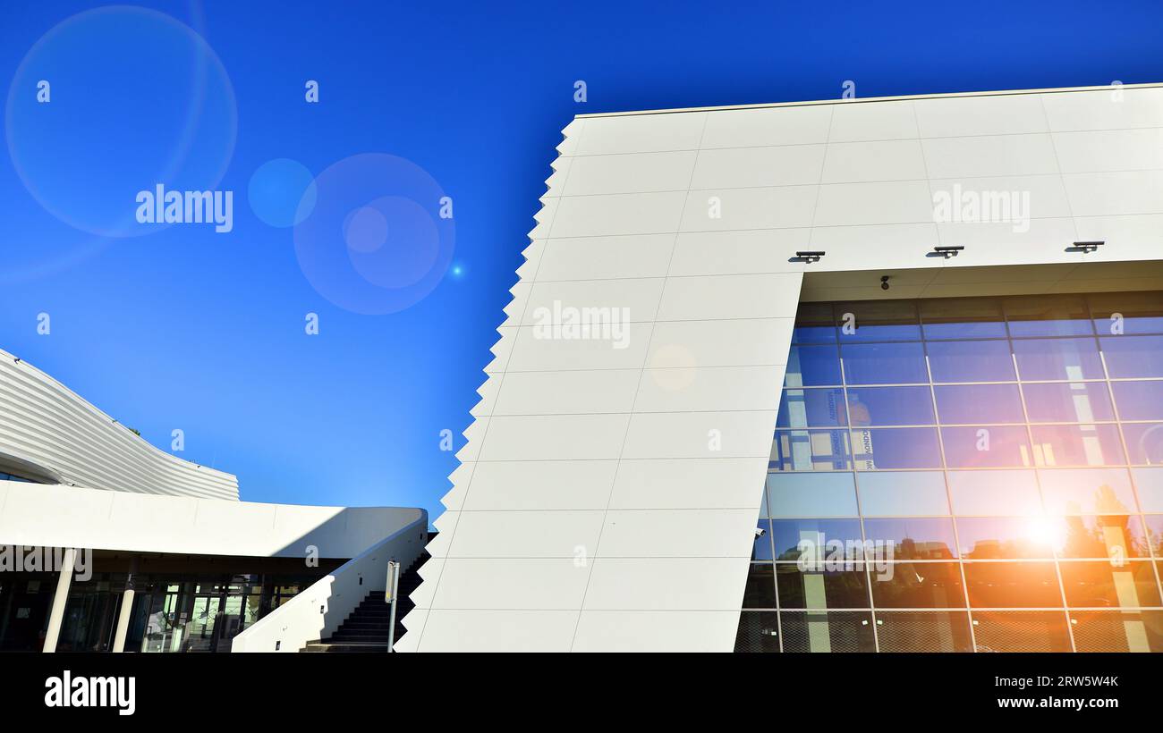Minimalist photo of an exterior of a modern tin building with big glass ...