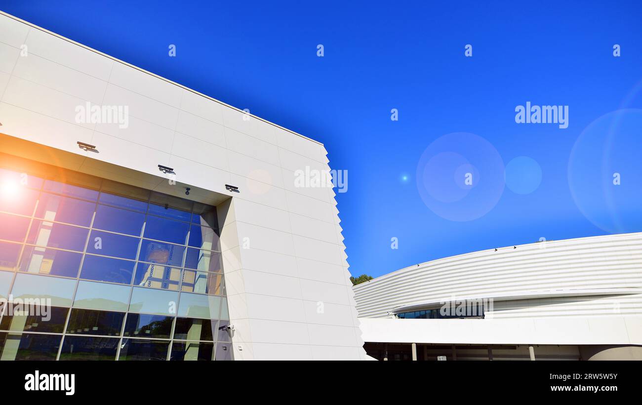 Minimalist photo of an exterior of a modern tin building with big glass ...