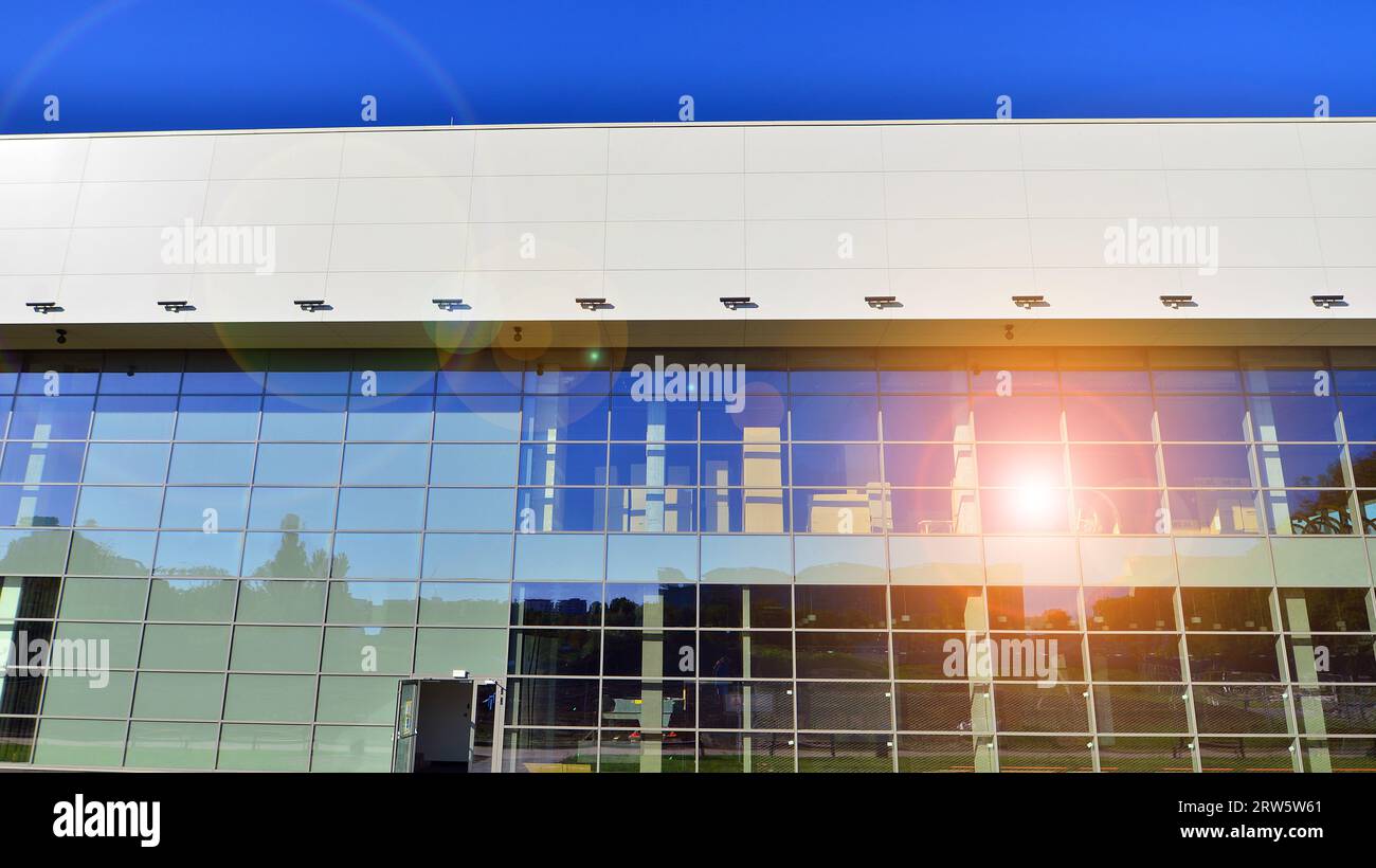 Minimalist photo of an exterior of a modern tin building with big glass ...