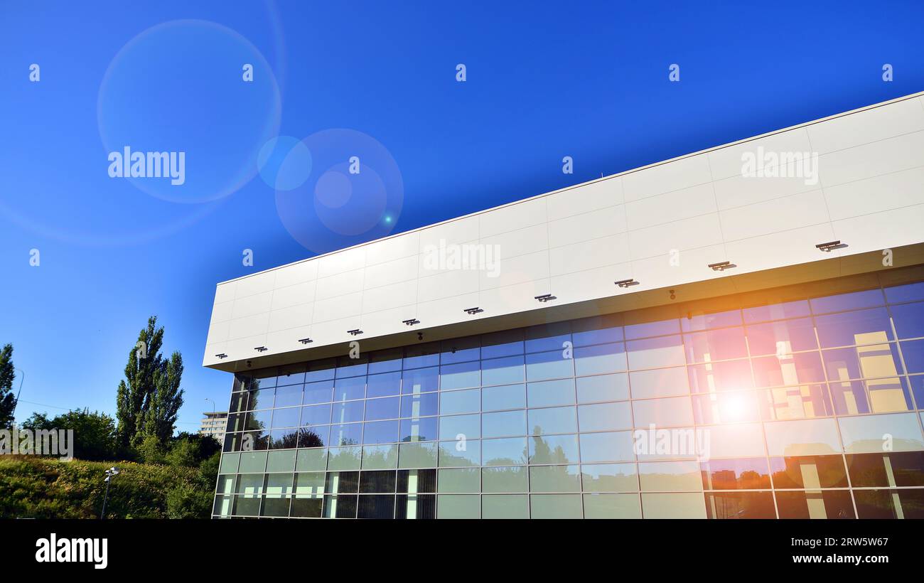 Minimalist photo of an exterior of a modern tin building with big glass ...