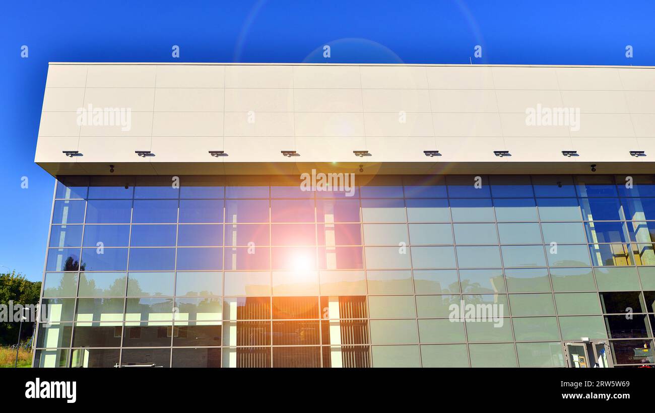 Minimalist photo of an exterior of a modern tin building with big glass ...