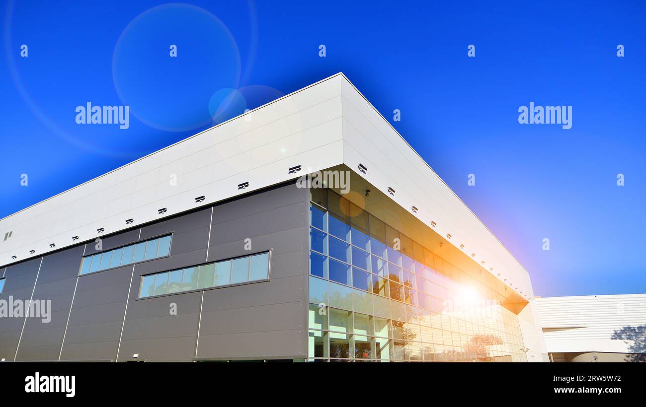 Minimalist photo of an exterior of a modern tin building with big glass ...