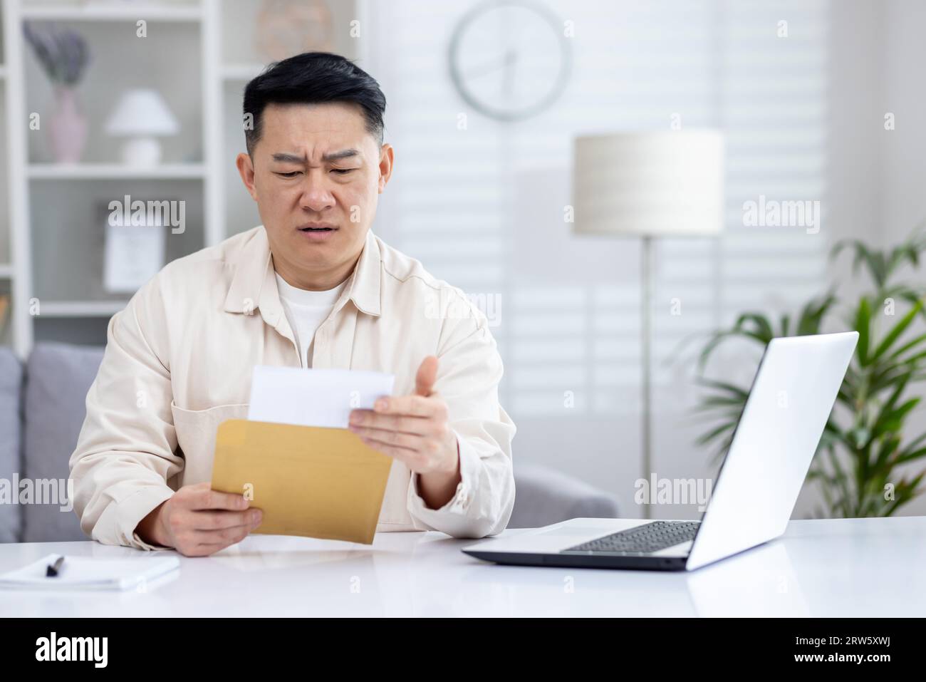 Upset and disappointed man in home office received message mail ...