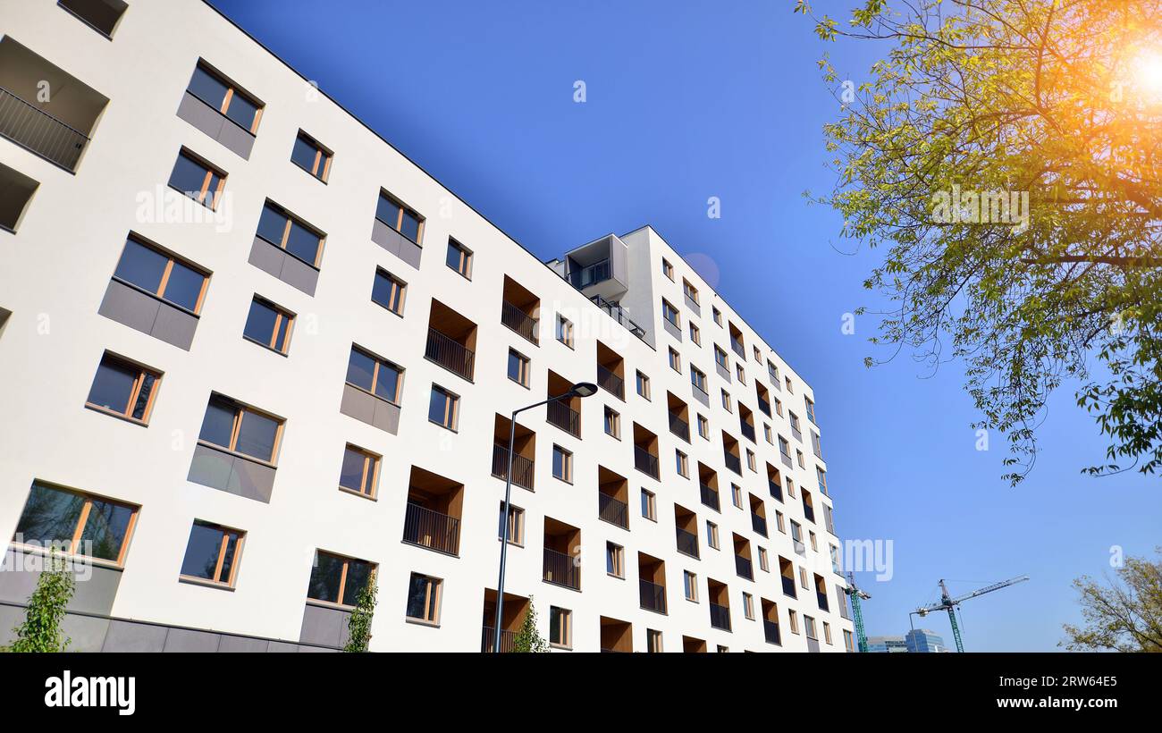 Modern apartment building and green trees. Ecological housing ...