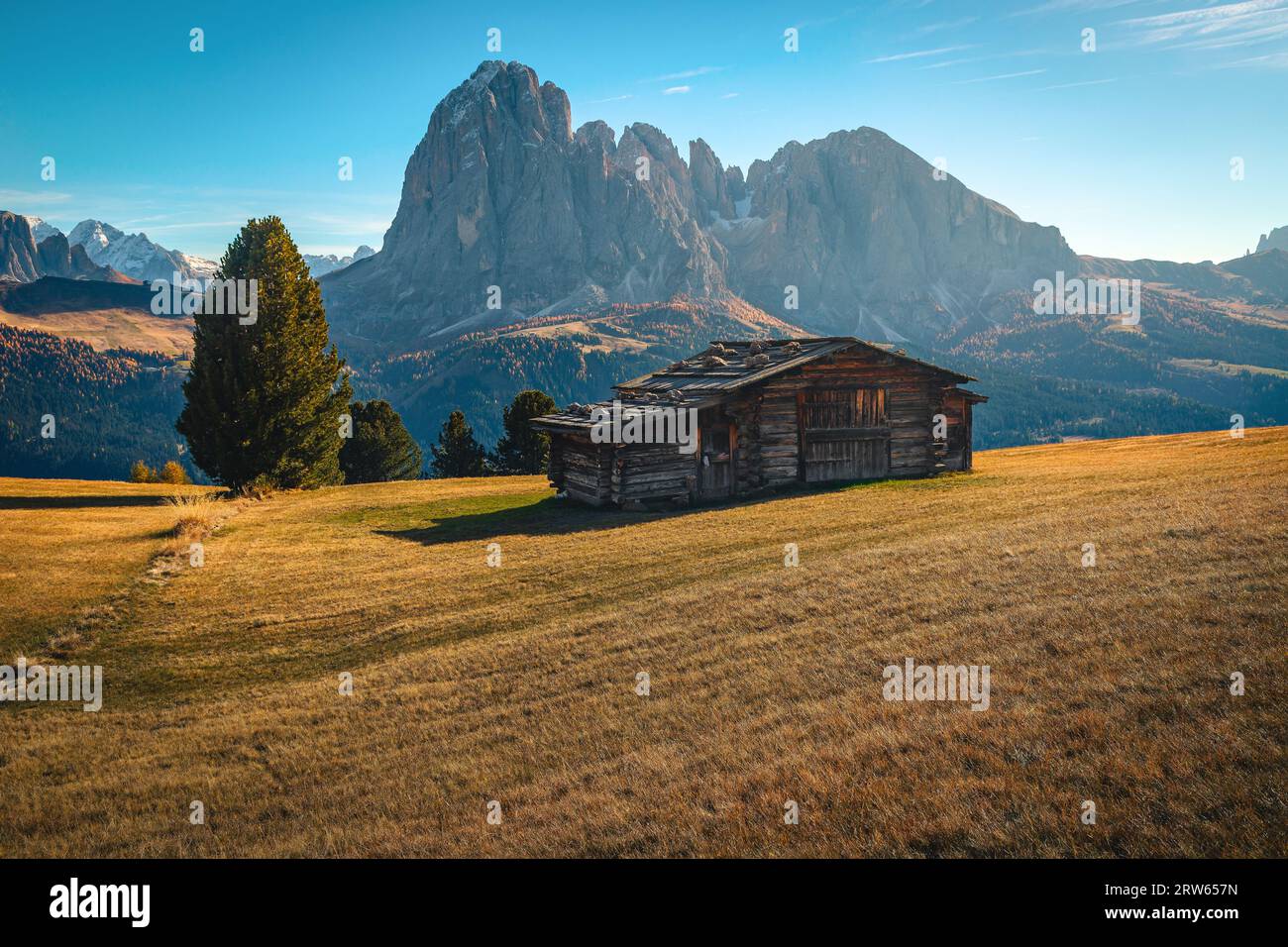 Old wooden hut on the mountain pasture and spectacular mountain ridge ...