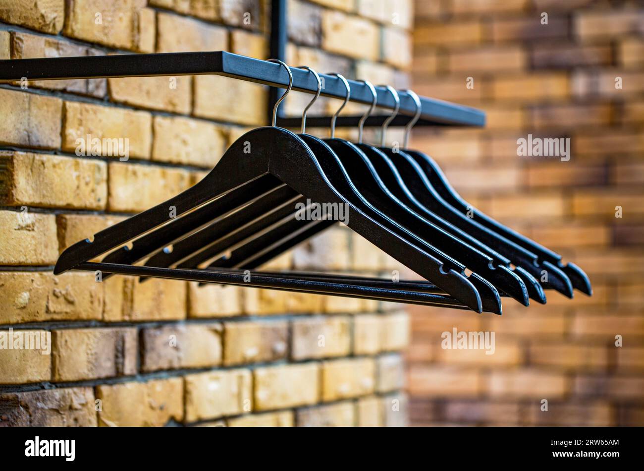 Wood Hangers coat. Many wooden black hangers on a rod. Store concept ...