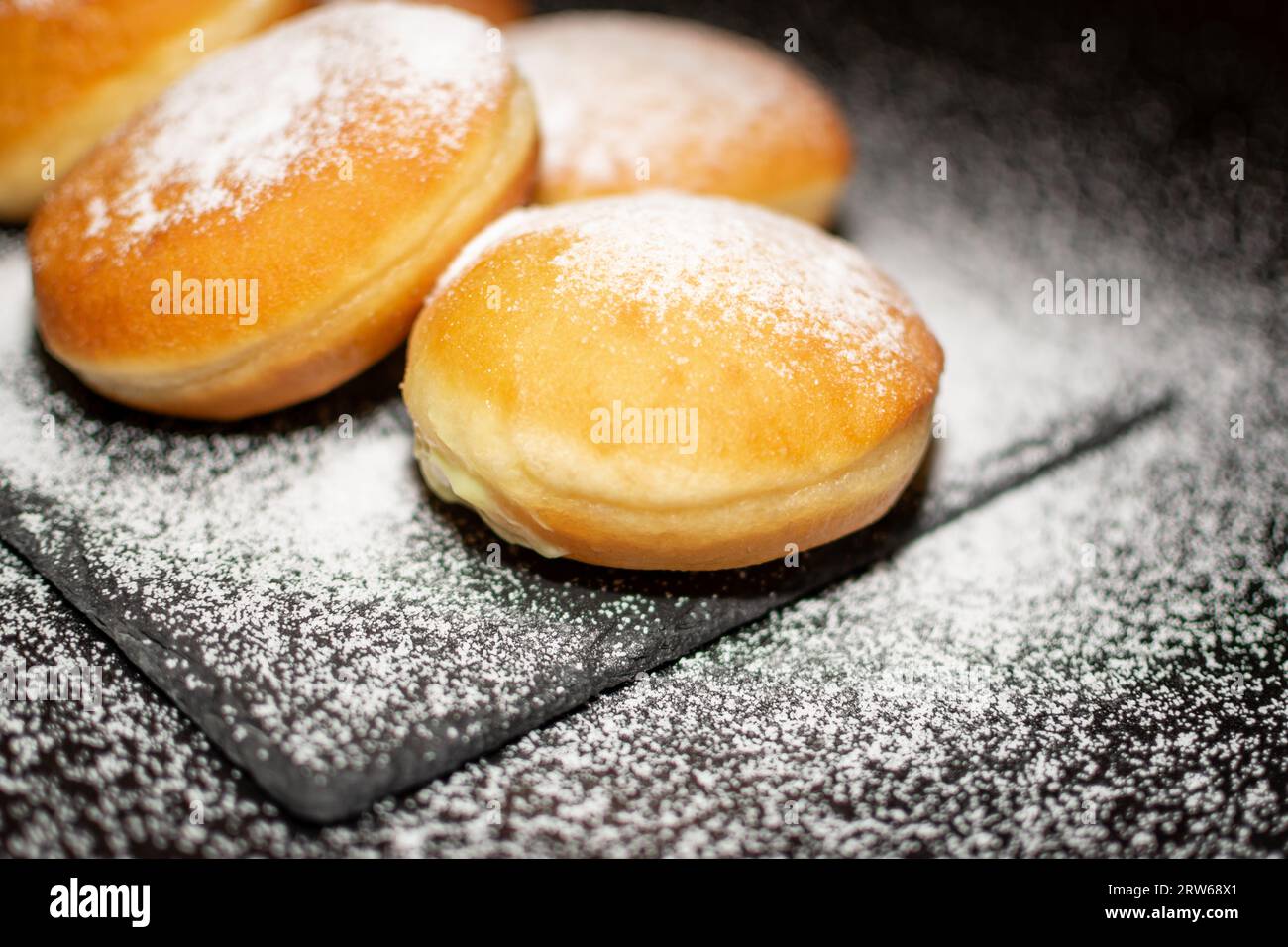 German Krapfen with drizzling glazed sprinkles in black elegant ...