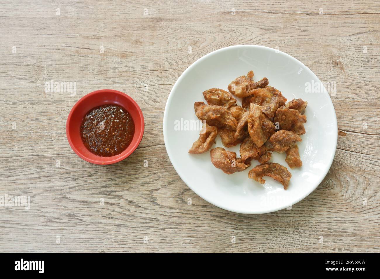 crispy fried pork innards with flour on plate dipping with spicy ...