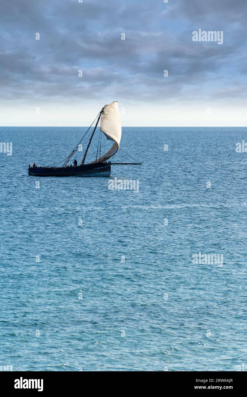 sailing dhow vessel silhouetted on the open ocean with large powerful ...