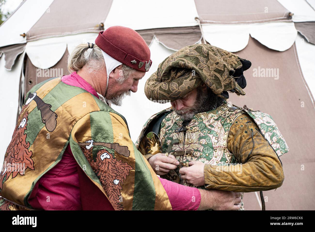 Kenilworth England July 29th 2023 A squire is arming his knight the ...