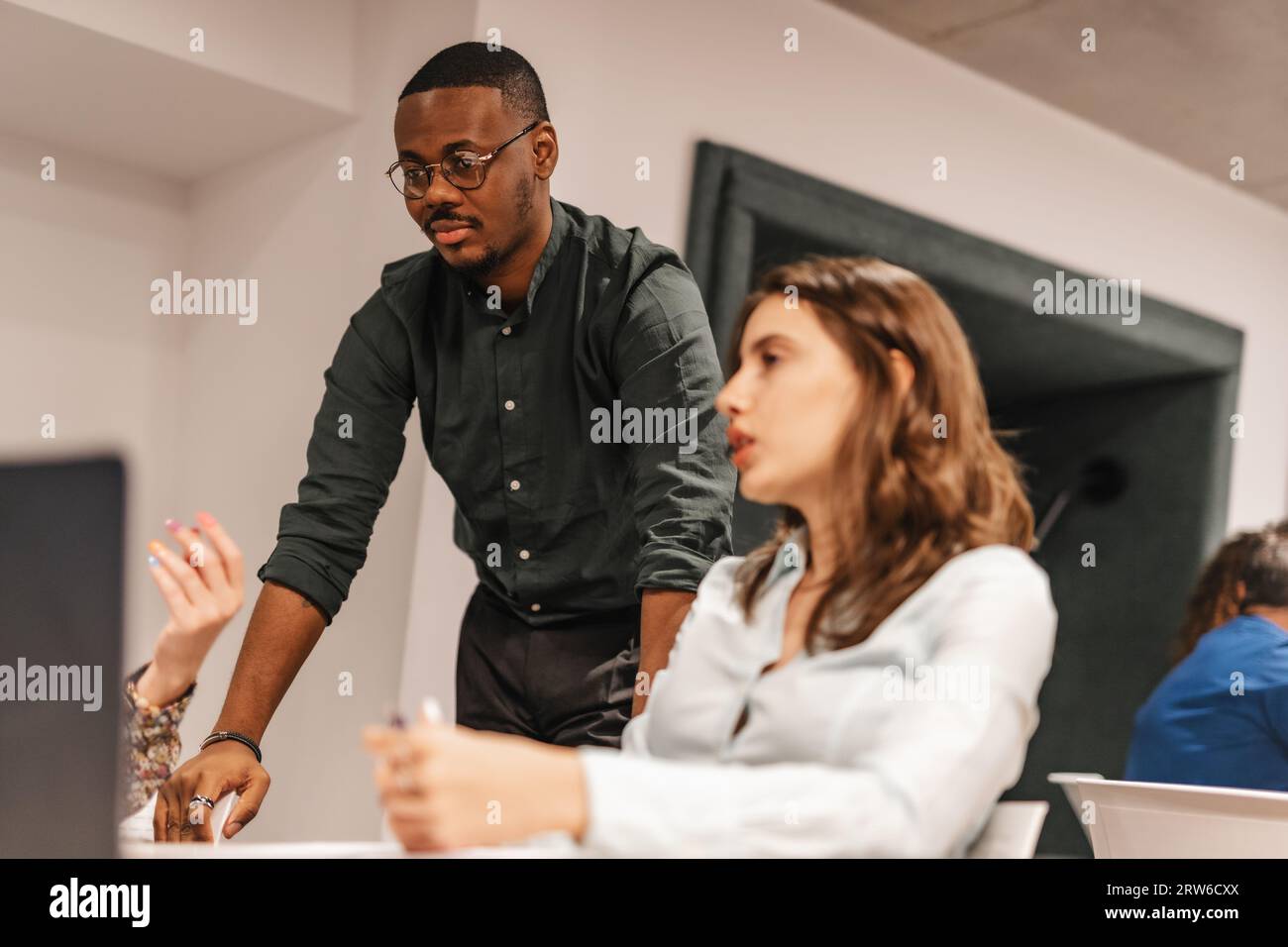 Good looking male, supervisor, working together with his Caucasian ...