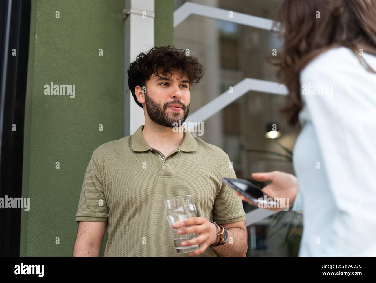 Conversation between two young colleagues while taking a break from ...