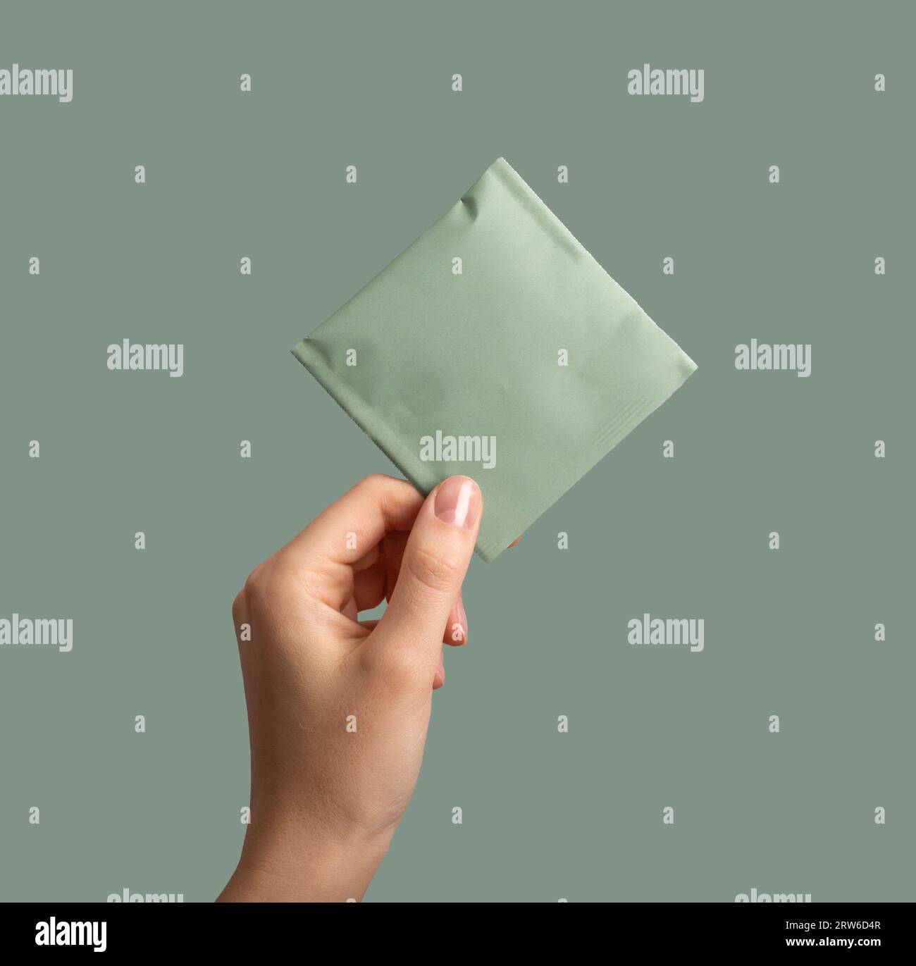 Tea bag, sachet package mockup. Green teabag mock up in hand Stock ...