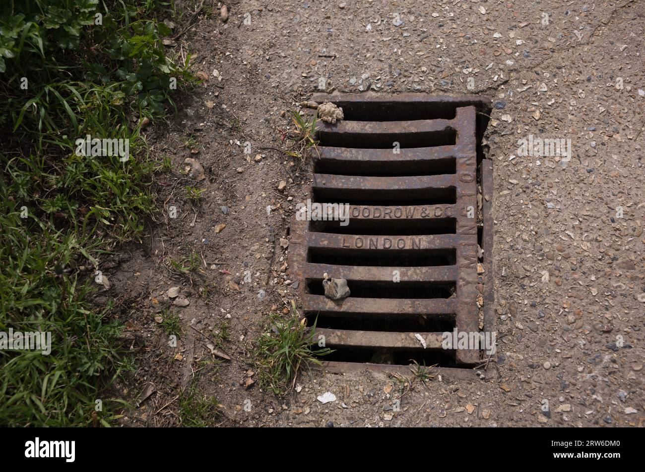 A traditional drain cover by Woodrow & Co and marked with the town name ...