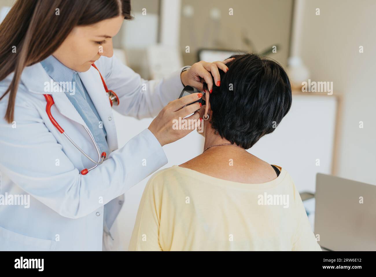 Elderly woman having ear video otoscopy examinations at modern medical ...