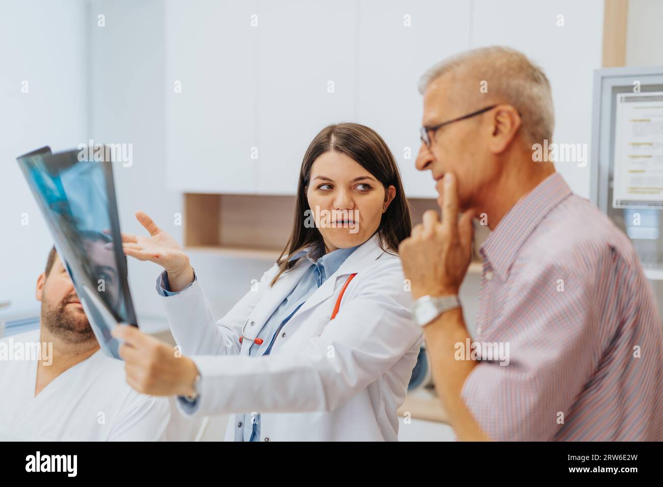 Doctor examines carefully ray lungs hi-res stock photography and images ...