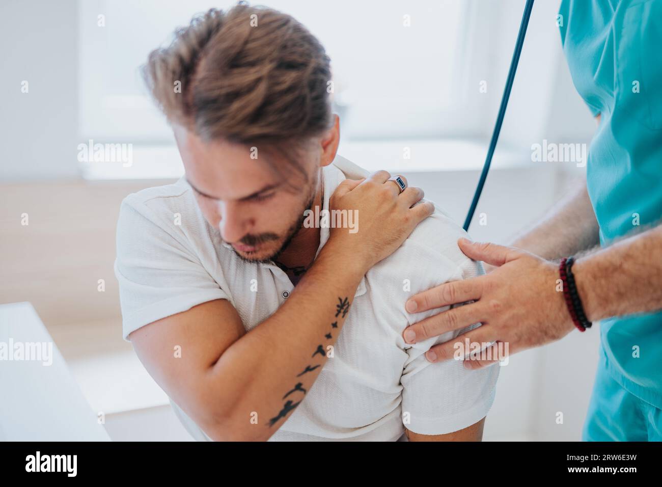 Knowledgeable physician carefully examining male patient, checking ...