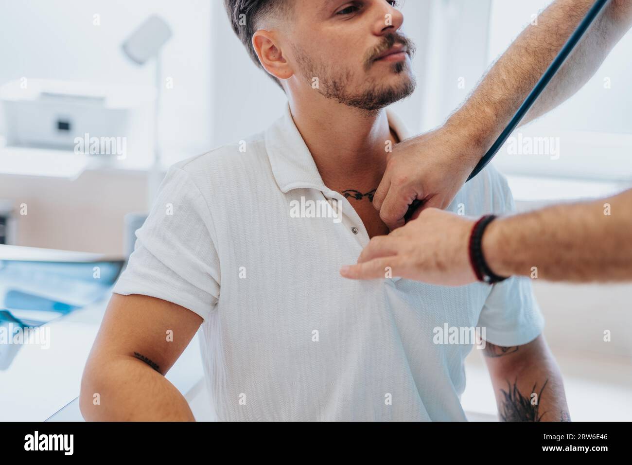 Experienced doctor examining male patient's health indoors. Careful ...