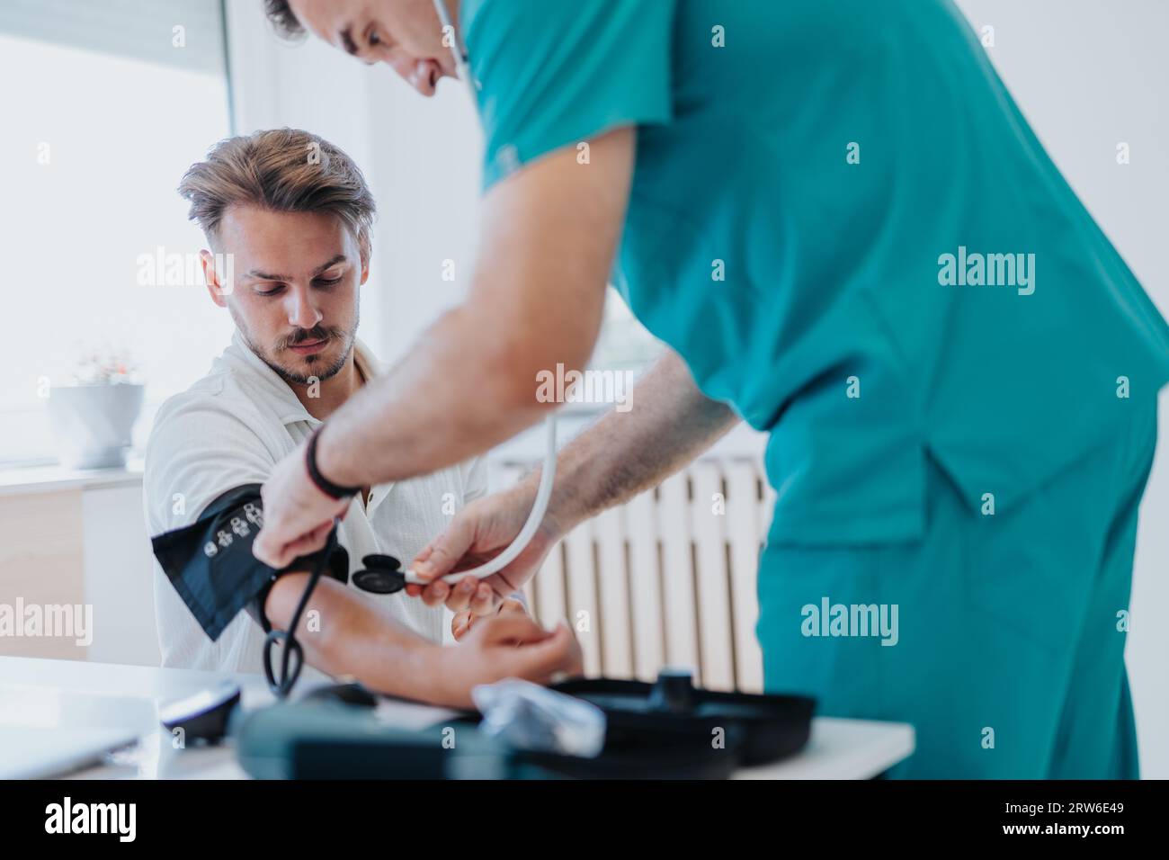 Experienced doctor measures blood pressure and checks heart rate of ...