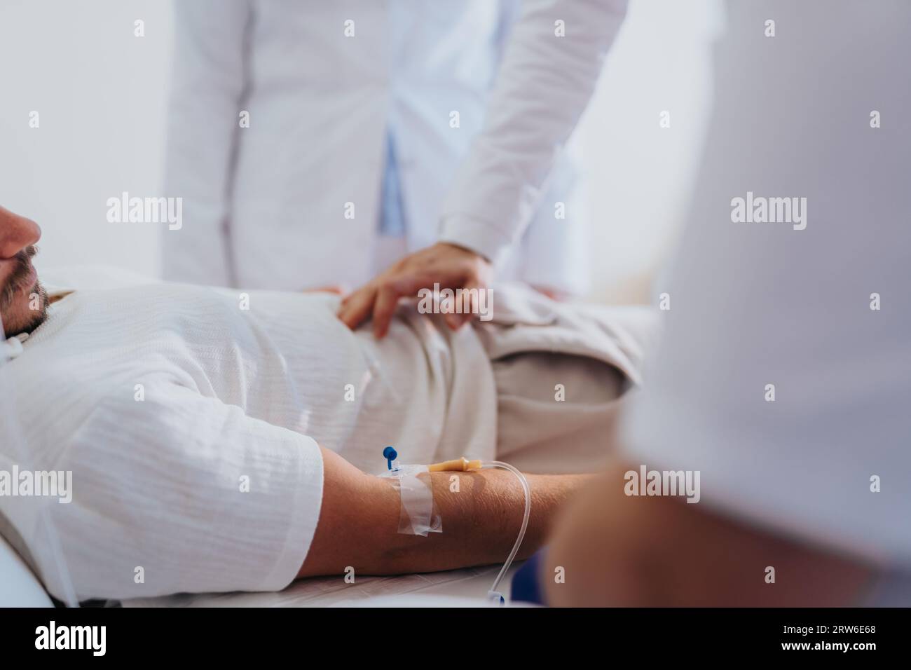 Doctor giving infusion therapy to patient in hospital room. Expert ...